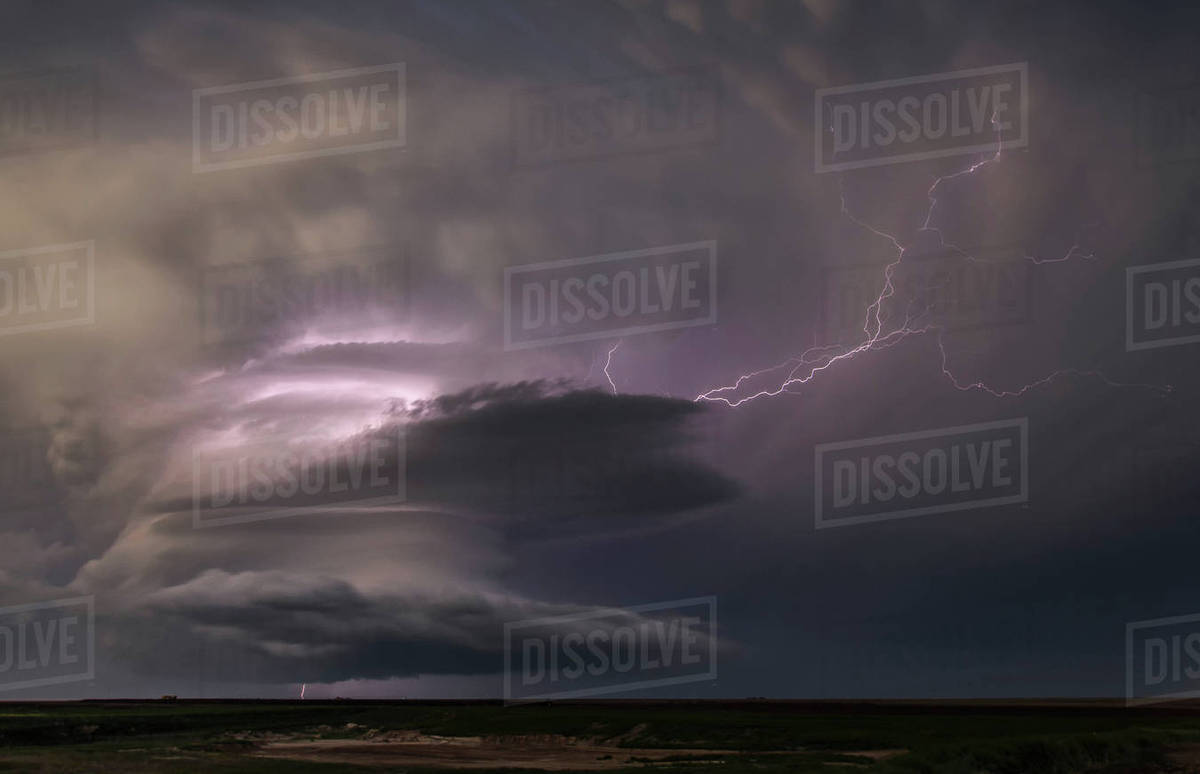Powerful electrical storm with lightning arcing out of the updraft into ...