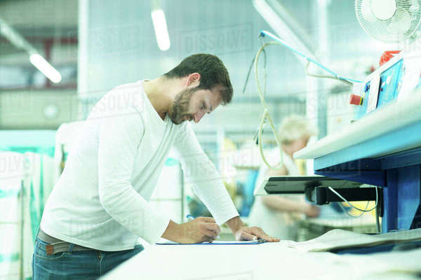 Man working in launderette making notes - Royalty-free Stock Photo ...
