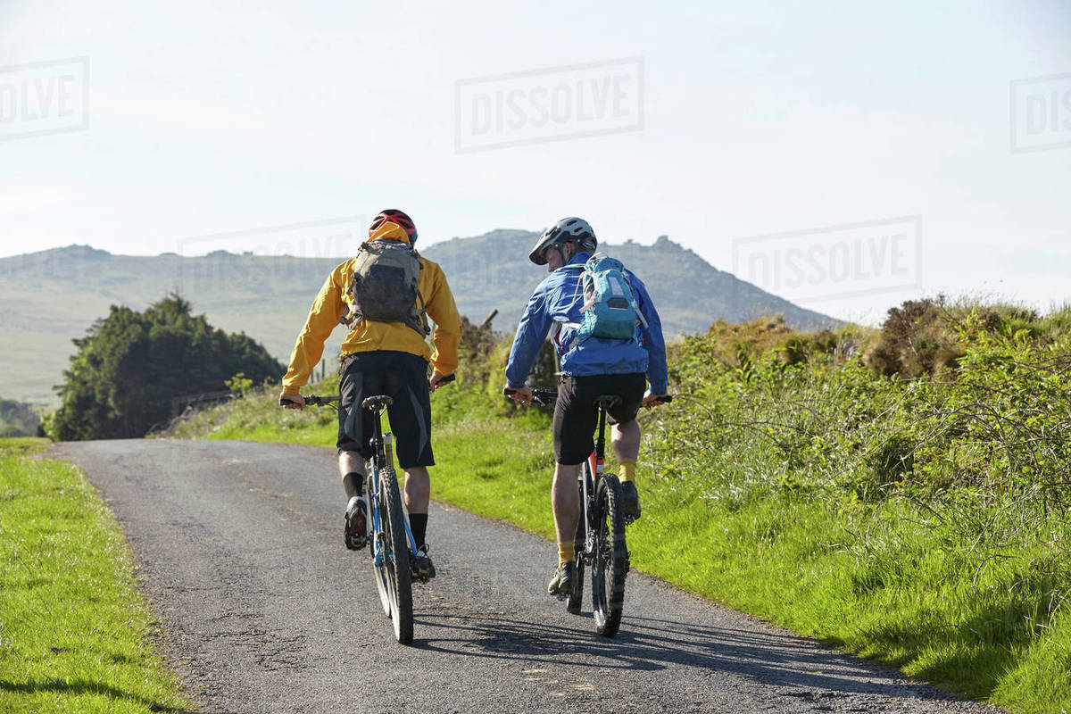 Rear view of cyclists cycling on rural road - Royalty-free Stock Photo ...