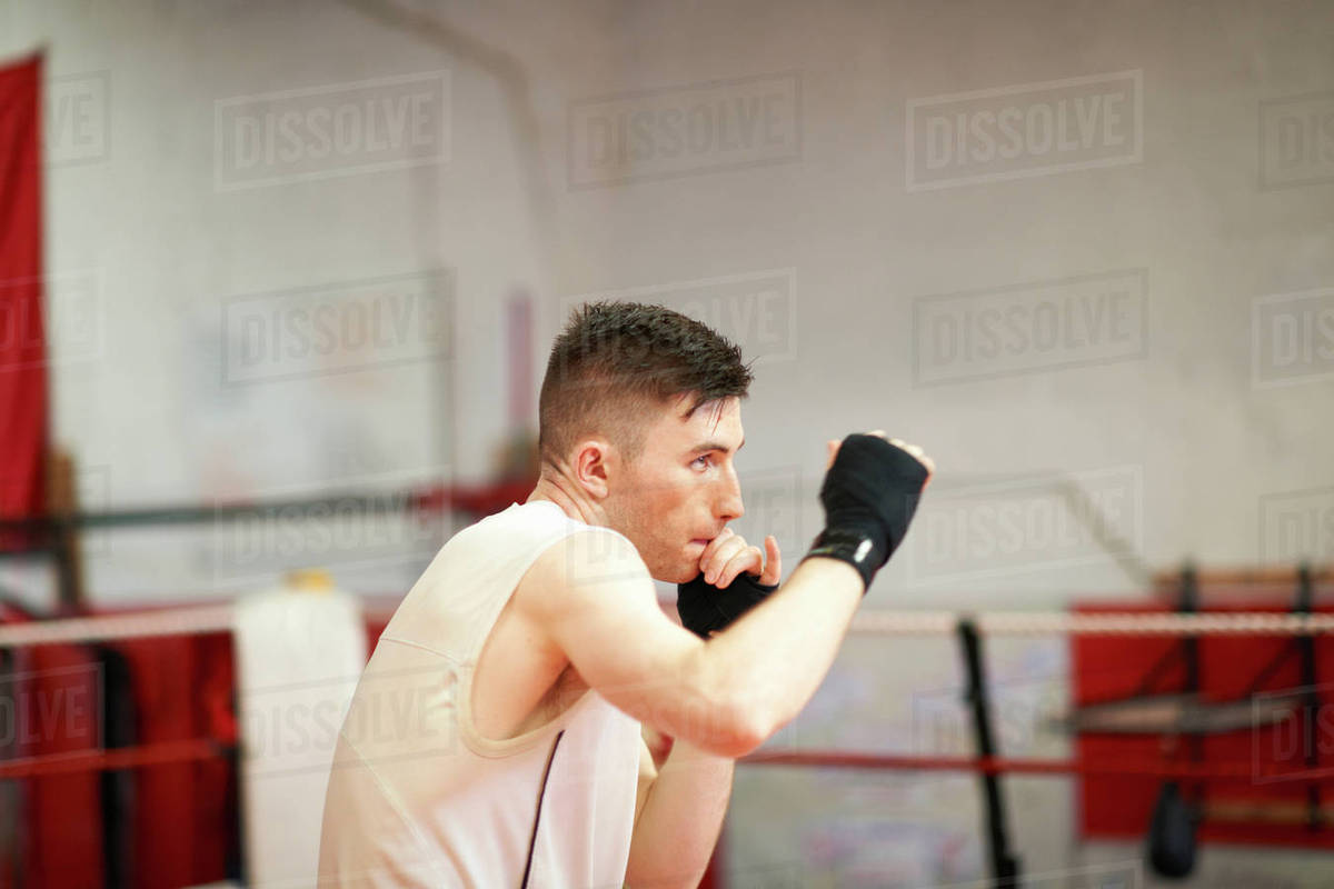 Boxer practising in boxing ring - Stock Photo - Dissolve