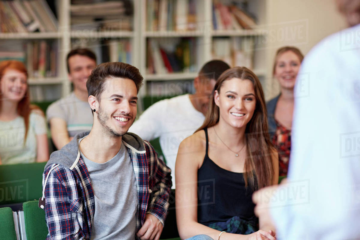 Over shoulder view of lecturer lecturing group of students in higher ...