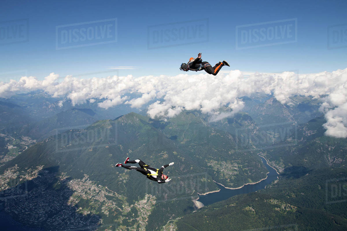 Freestyle skydiving team training together. One man performing air ...