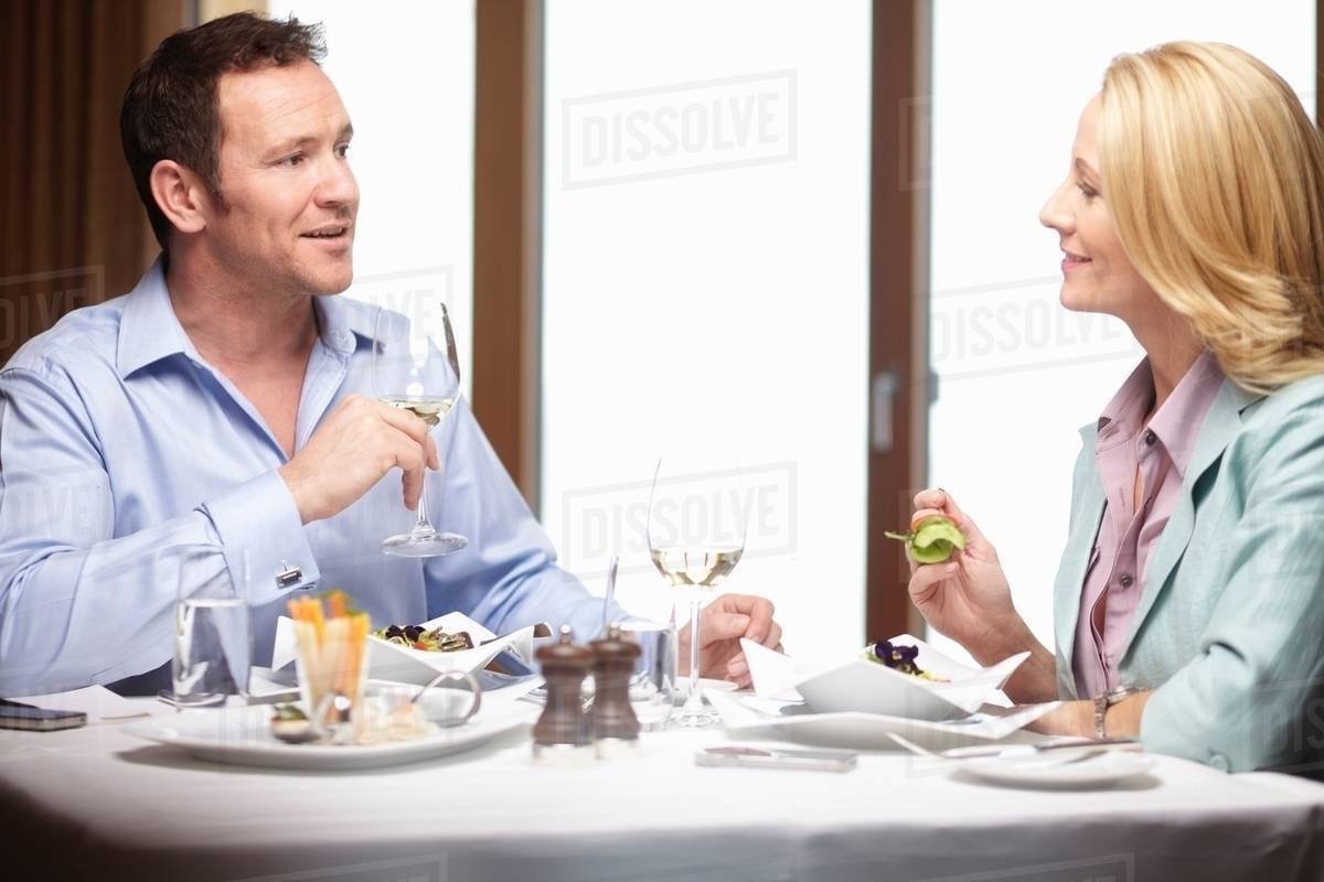 Business people talking in cafe - Stock Photo - Dissolve