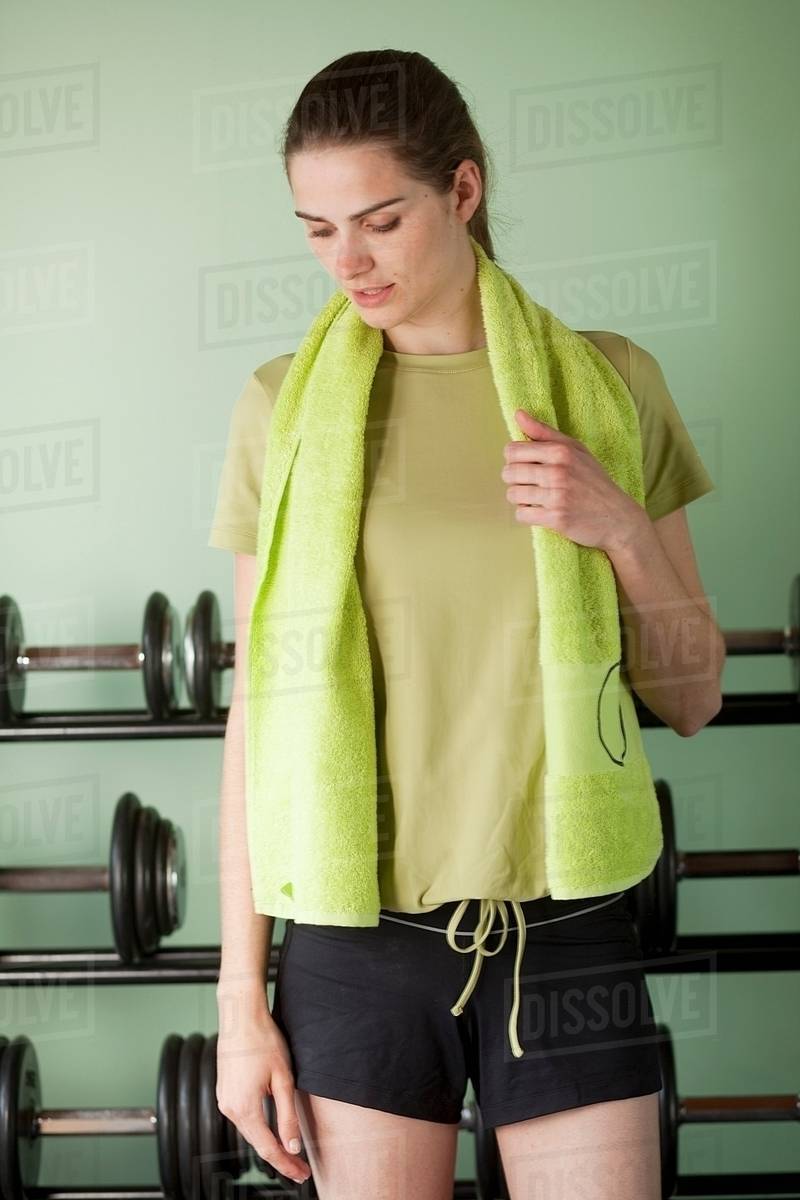 Woman wearing towel in gym - Stock Photo - Dissolve