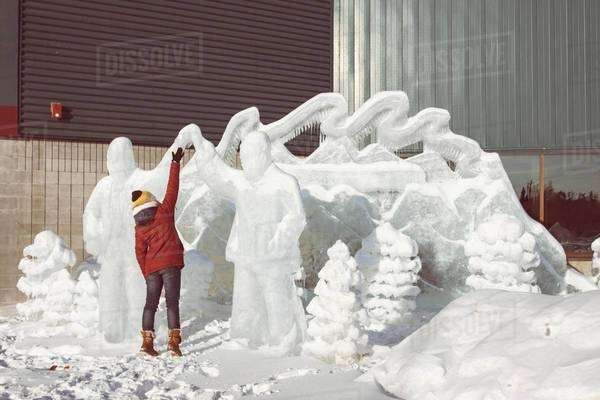 Woman touching ice sculpture - Stock Photo - Dissolve