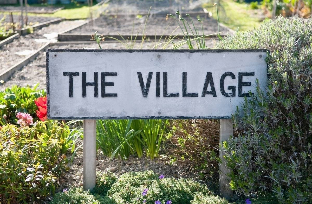 Village sign in garden - Royalty-free Stock Photo | Dissolve