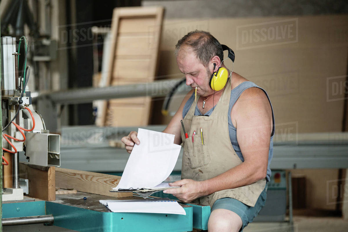 Carpenter reading order instructions - Royalty-free Stock Photo | Dissolve