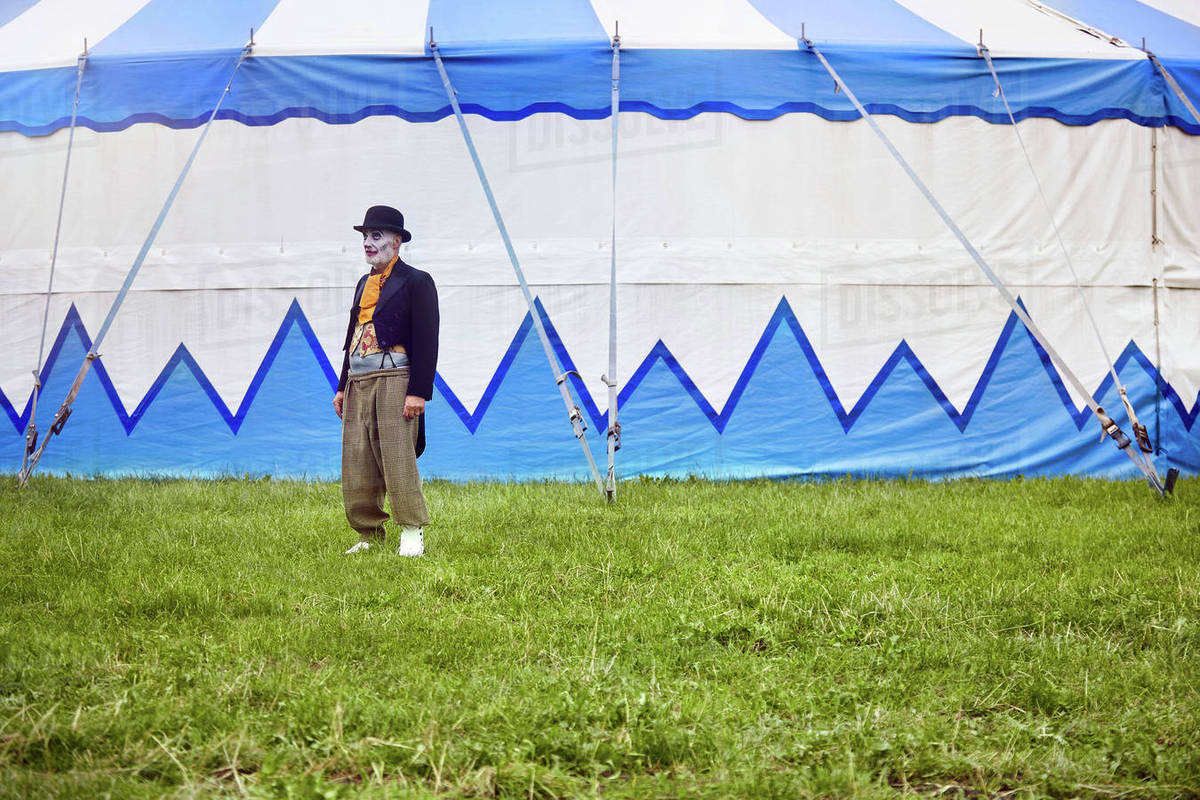 Portrait of senior male circus clown outside circus tent - Royalty-free ...