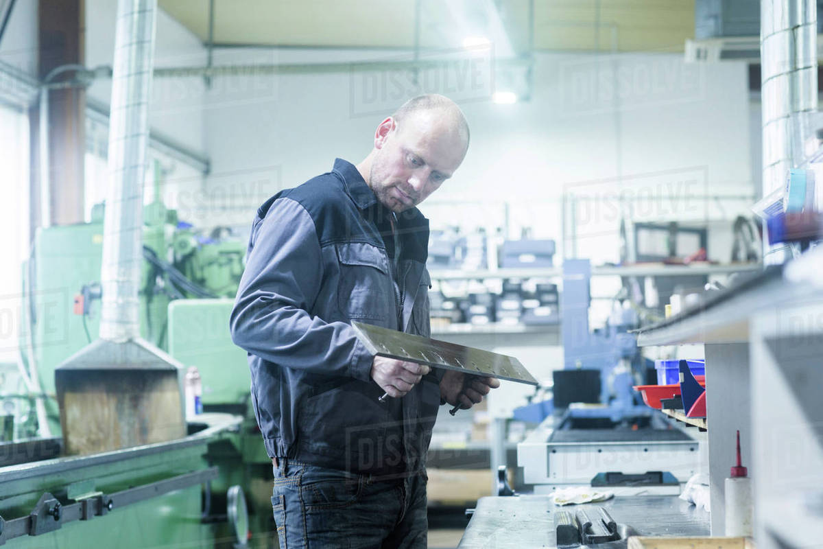 Man working in grinding workshop - Stock Photo - Dissolve