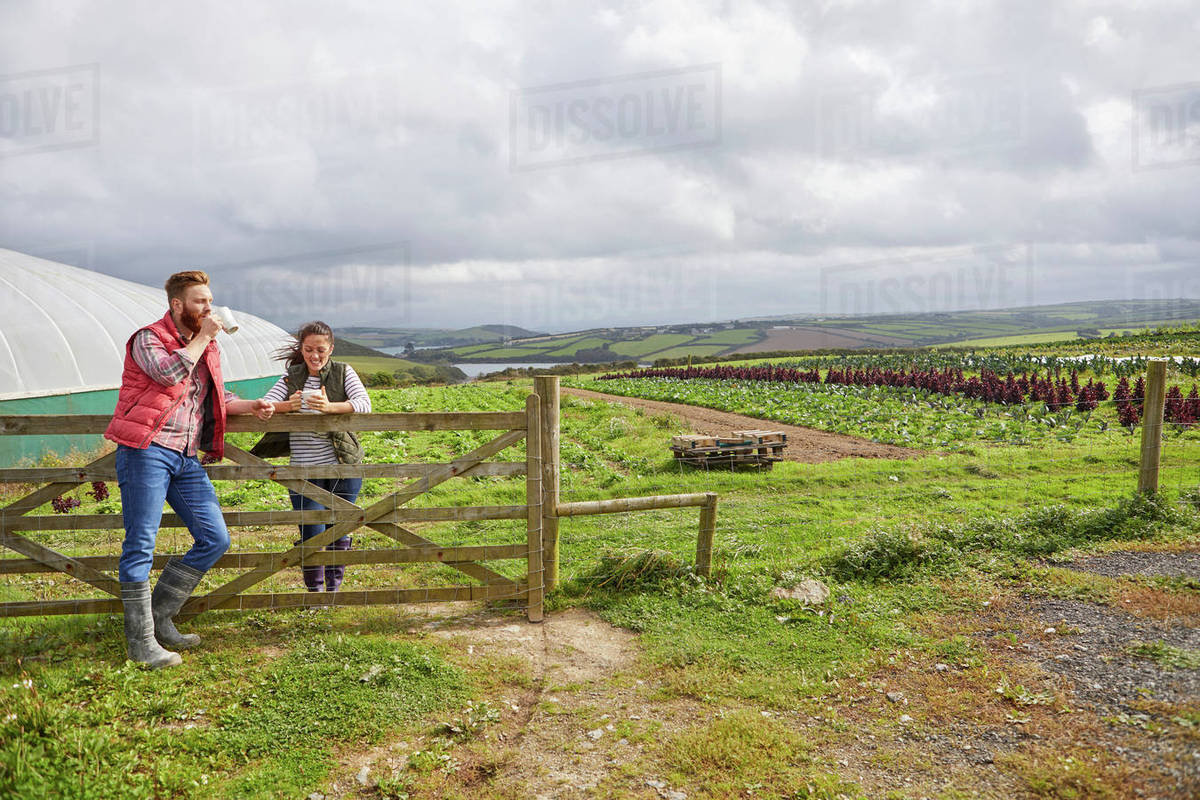 Couple on farm enjoying a hot drink - Royalty-free Stock Photo | Dissolve