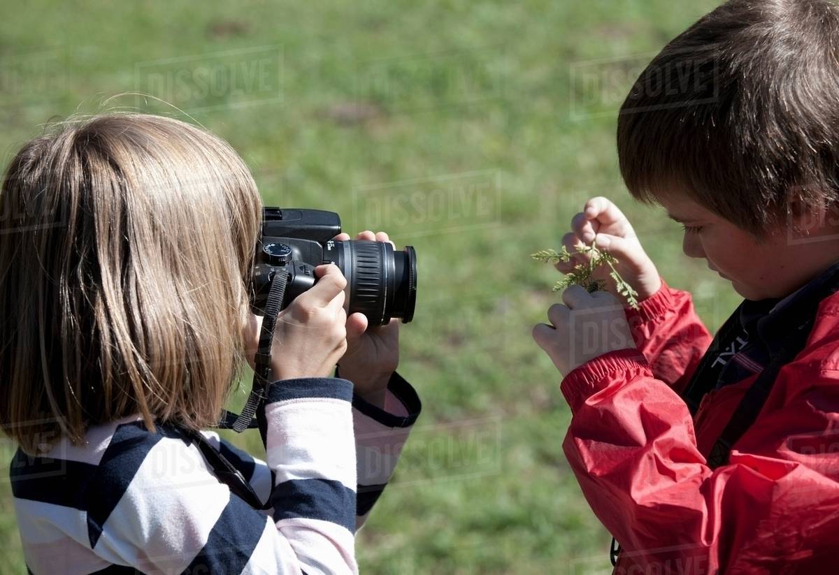 Children taking pictures outdoors - Royalty-free Stock Photo | Dissolve