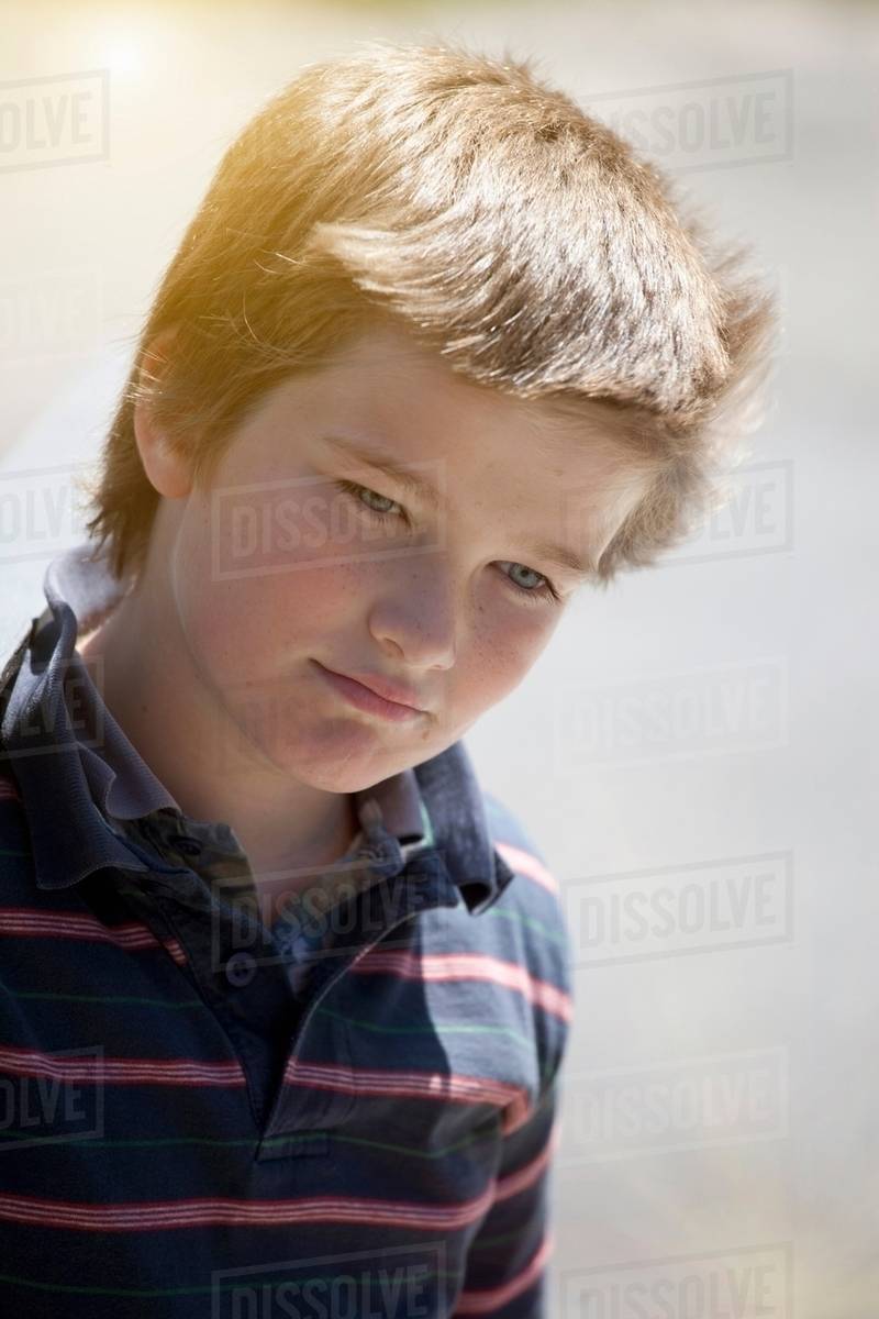 Close up of boys serious face - Royalty-free Stock Photo | Dissolve