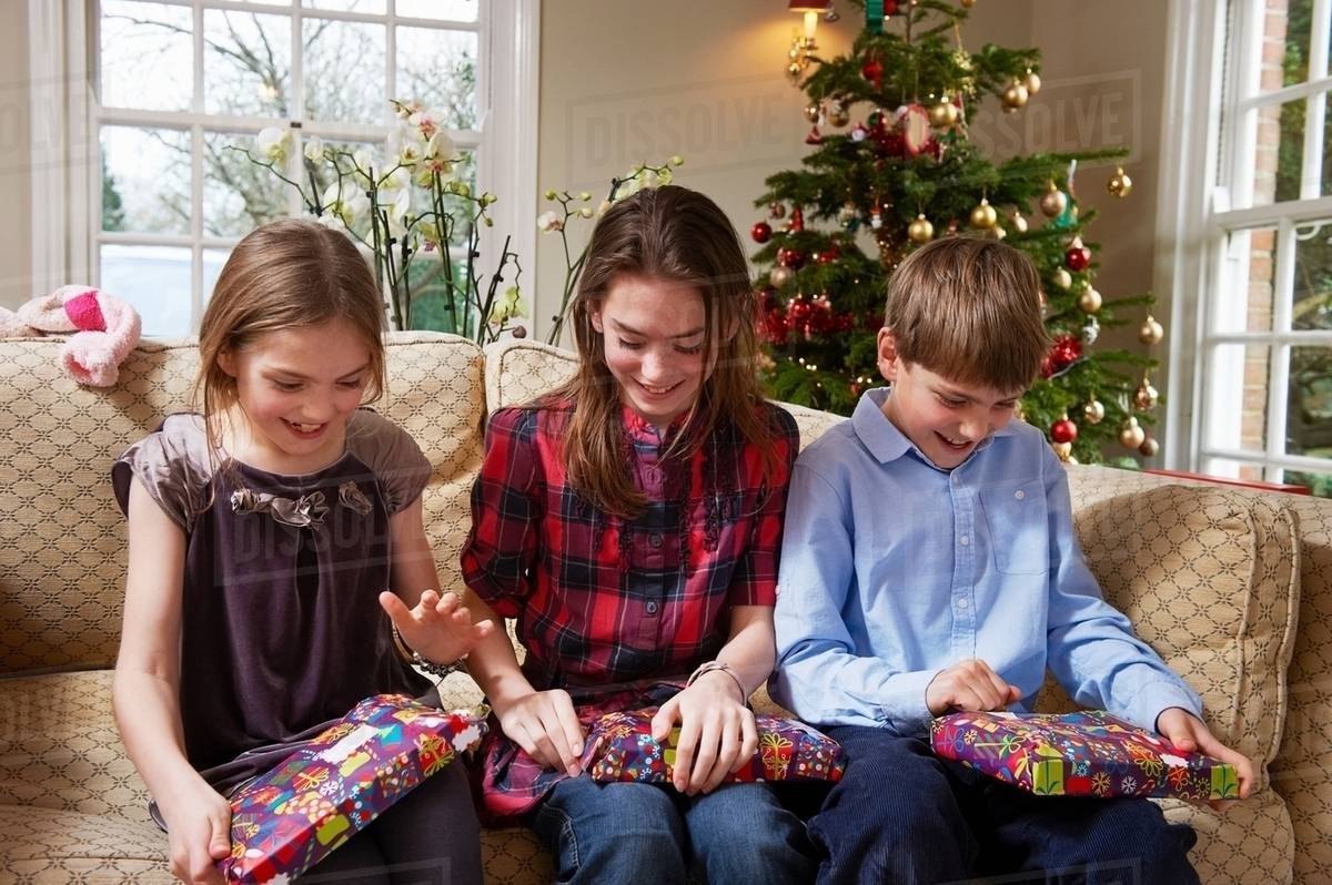 Children opening Christmas gifts - Royalty-free Stock Photo | Dissolve