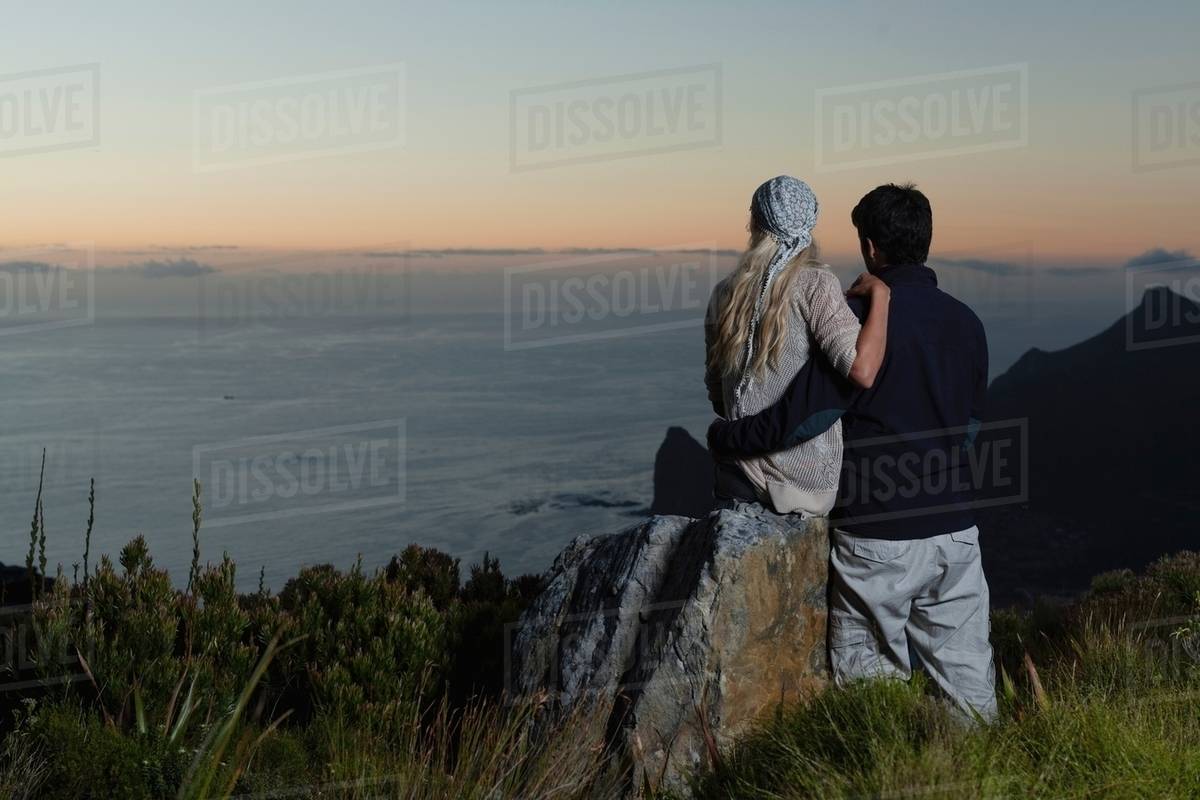 Couple overlooking coastal view - Royalty-free Stock Photo | Dissolve