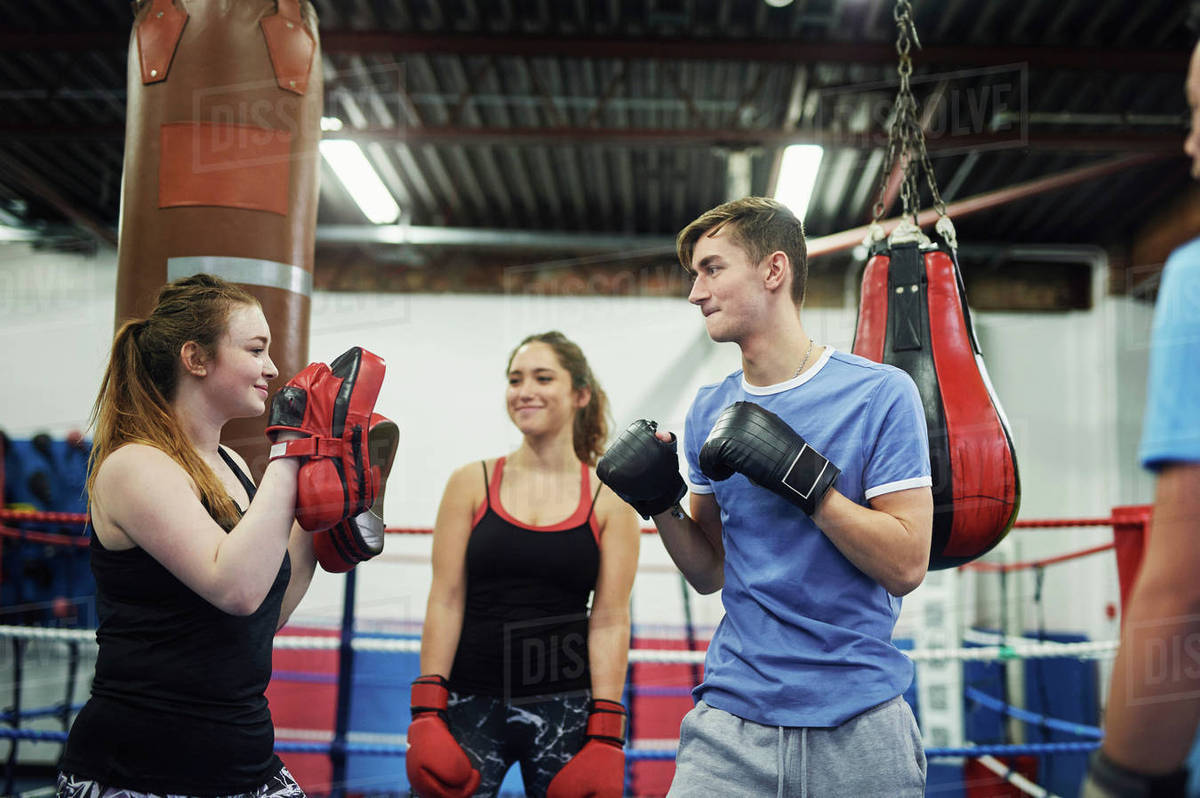 Male boxer training, poised to punch teammates punch mitt - Stock Photo ...
