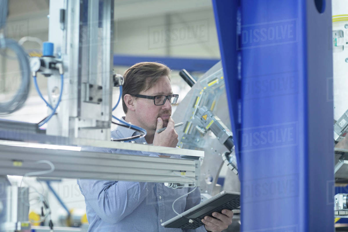 Engineer working in industrial plant - Stock Photo - Dissolve