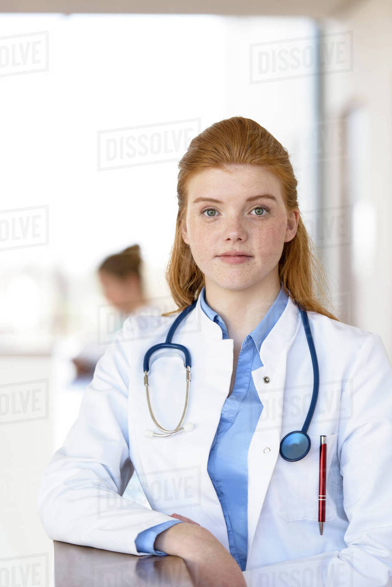 Portrait of red haired young female doctor in hospital - Stock Photo ...