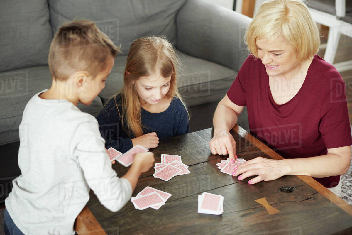 Grandmother and grandchildren playing cards at home - Royalty-free ...