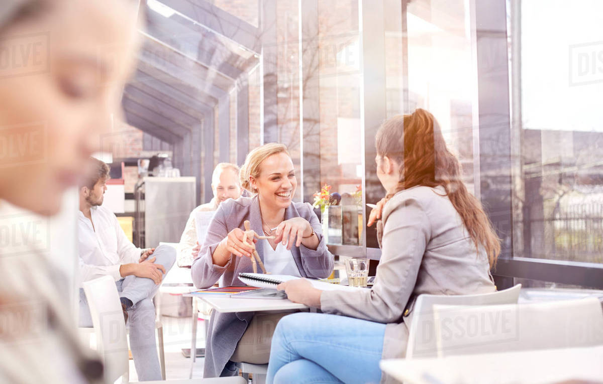 Businesswomen having discussion during working lunch in restaurant ...