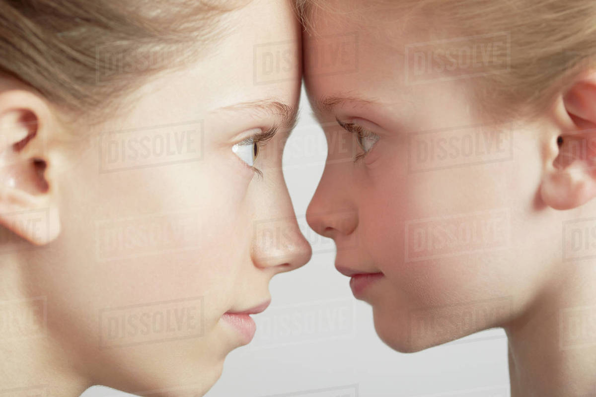 Portrait of two girls, face to face, close-up - Stock Photo - Dissolve