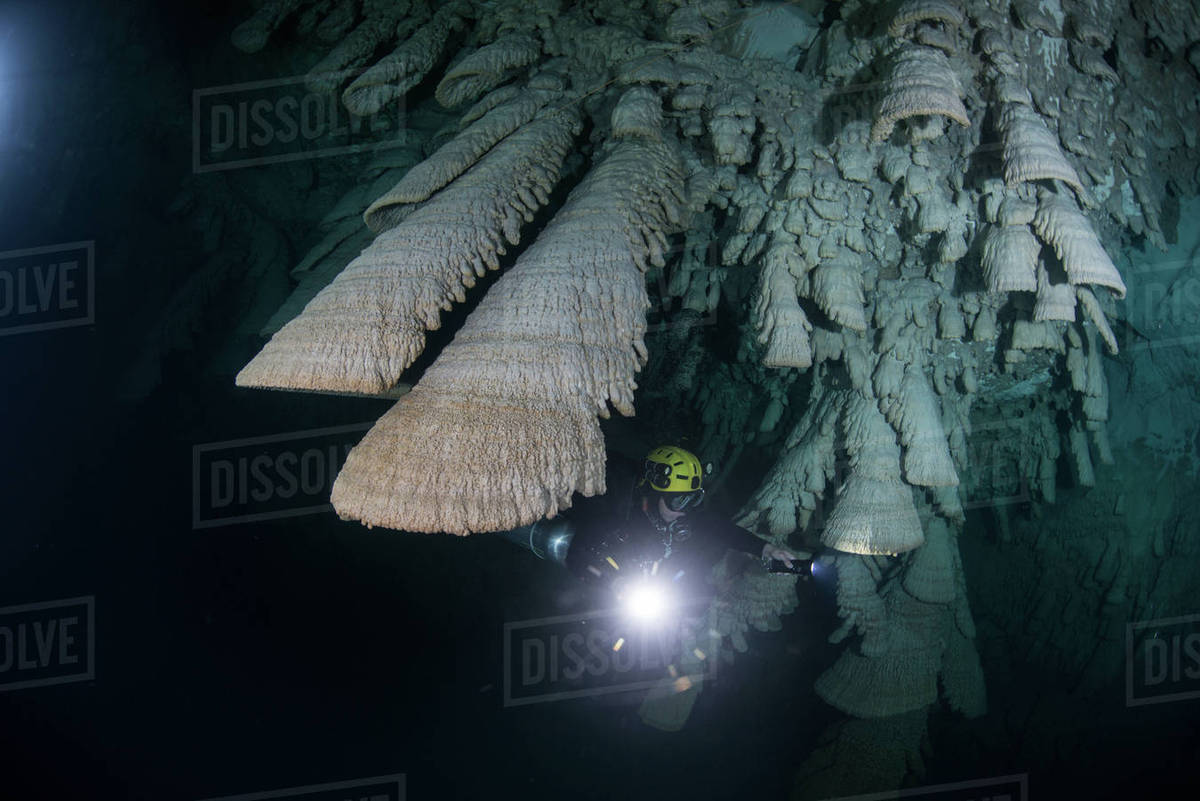 Scuba diver exploring unique natural formations known as "bells" in ...