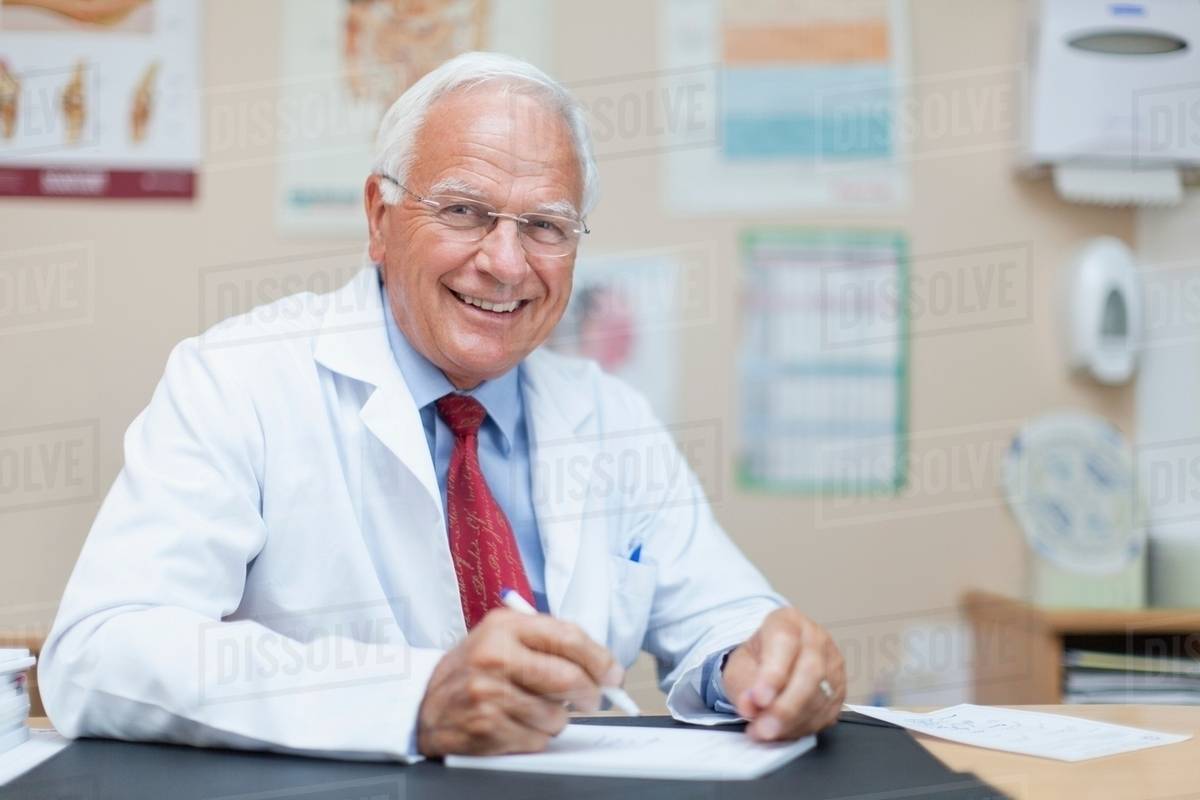 Doctor writing notes in office - Royalty-free Stock Photo | Dissolve