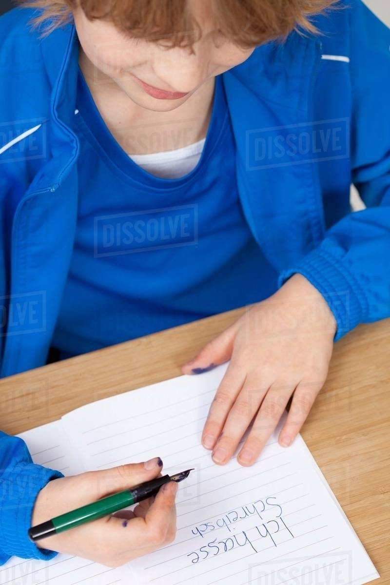 Student practicing handwriting in class - Stock Photo - Dissolve