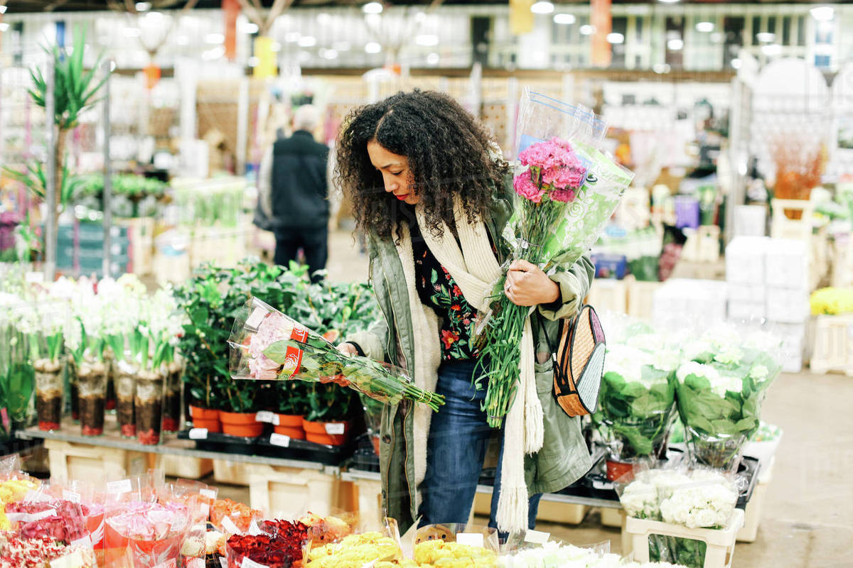 Female florist selecting flowers at new Covent Garden flower market ...