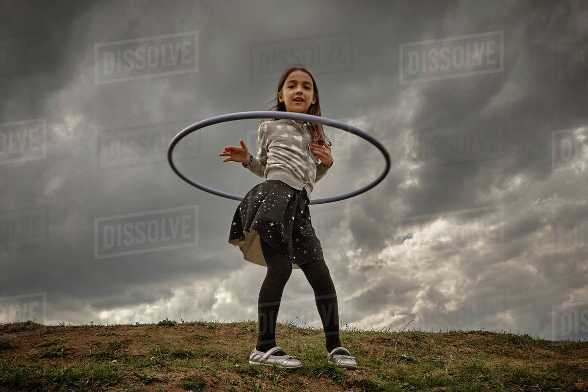 Girl playing with hoola hoop - Royalty-free Stock Photo | Dissolve