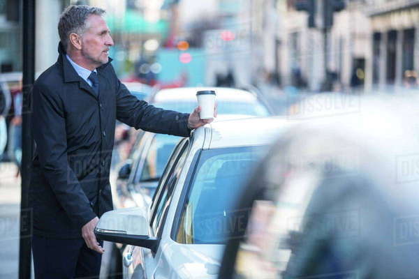 Man getting into car - Royalty-free Stock Photo | Dissolve