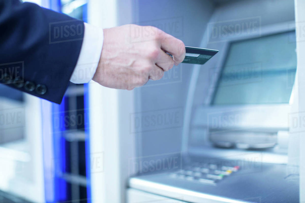 Man using cash machine - Stock Photo - Dissolve