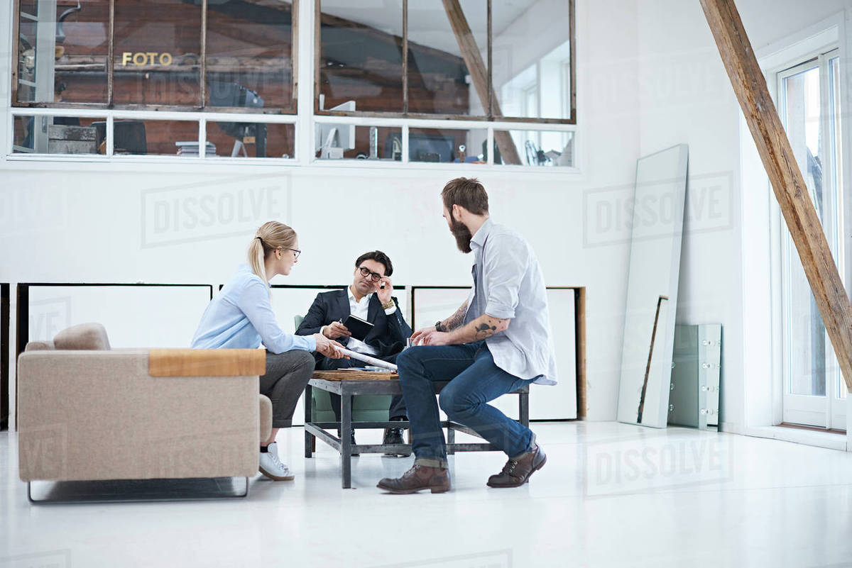Design team meeting on design studio sofa - Stock Photo - Dissolve