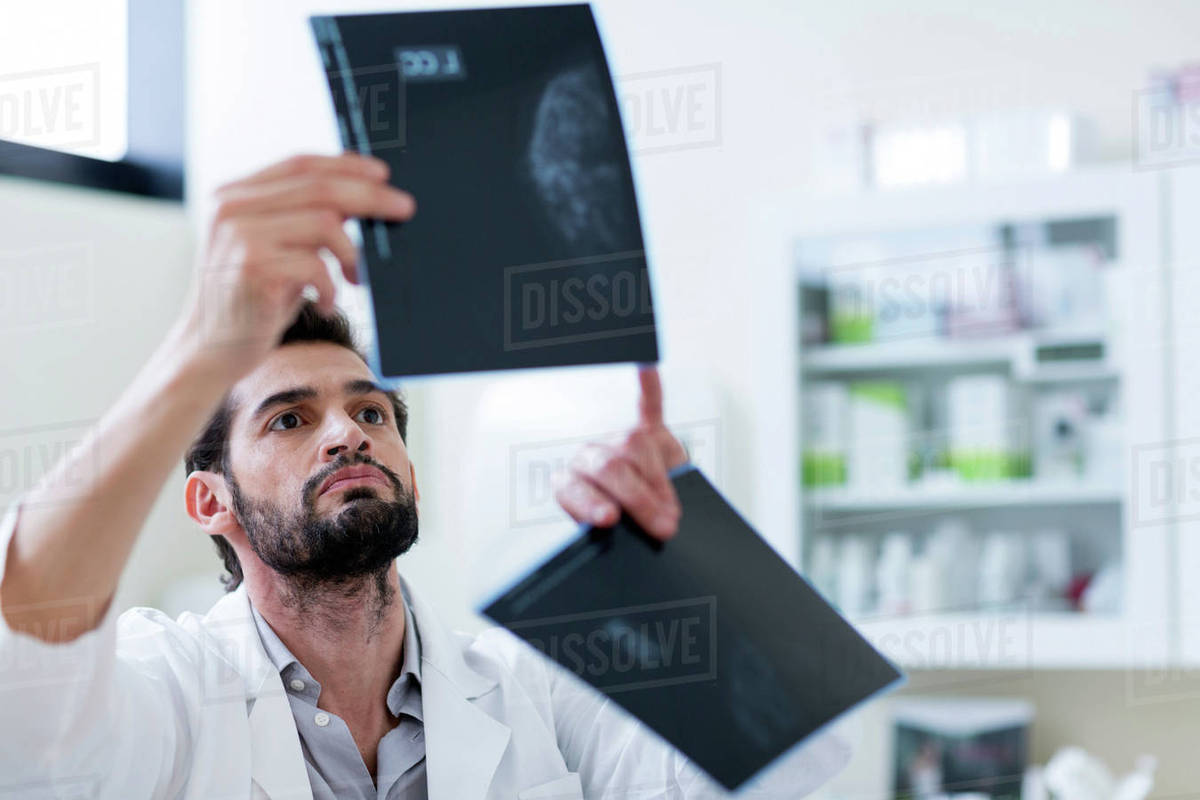 Doctor looking at xray image - Royalty-free Stock Photo | Dissolve