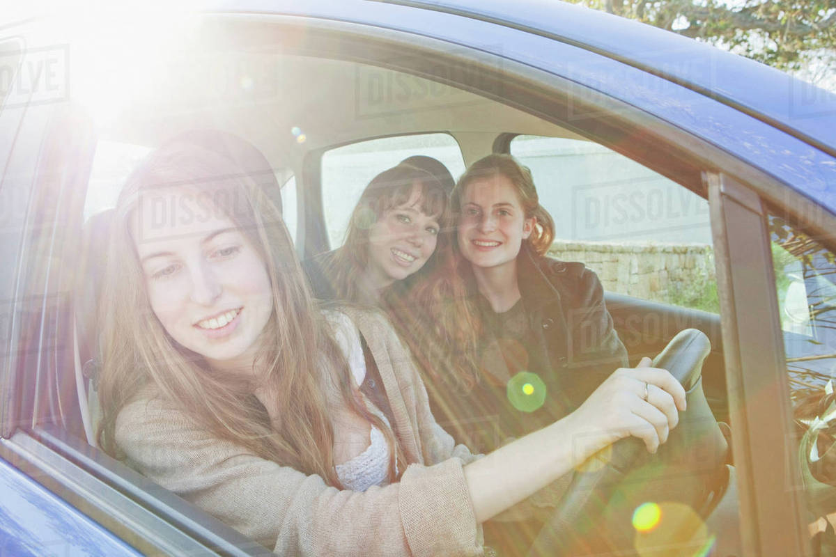 Teenage girls riding in car together - Royalty-free Stock Photo | Dissolve