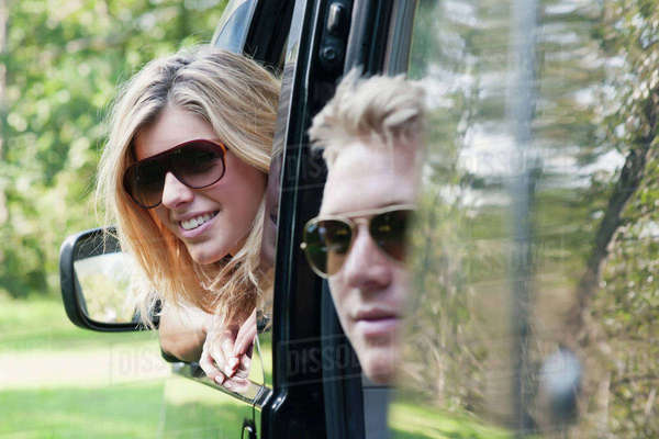 Couple peering out car windows - Royalty-free Stock Photo | Dissolve