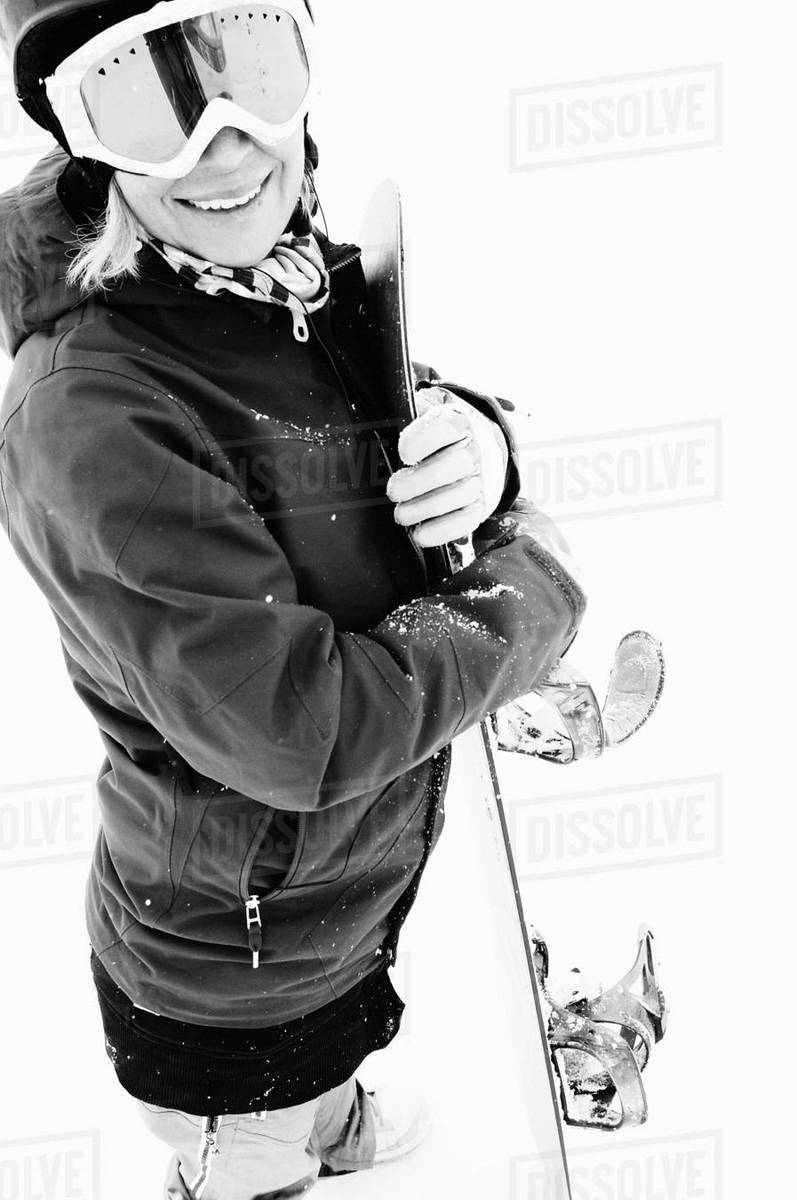 Snowboarder smiling in snow - Stock Photo - Dissolve