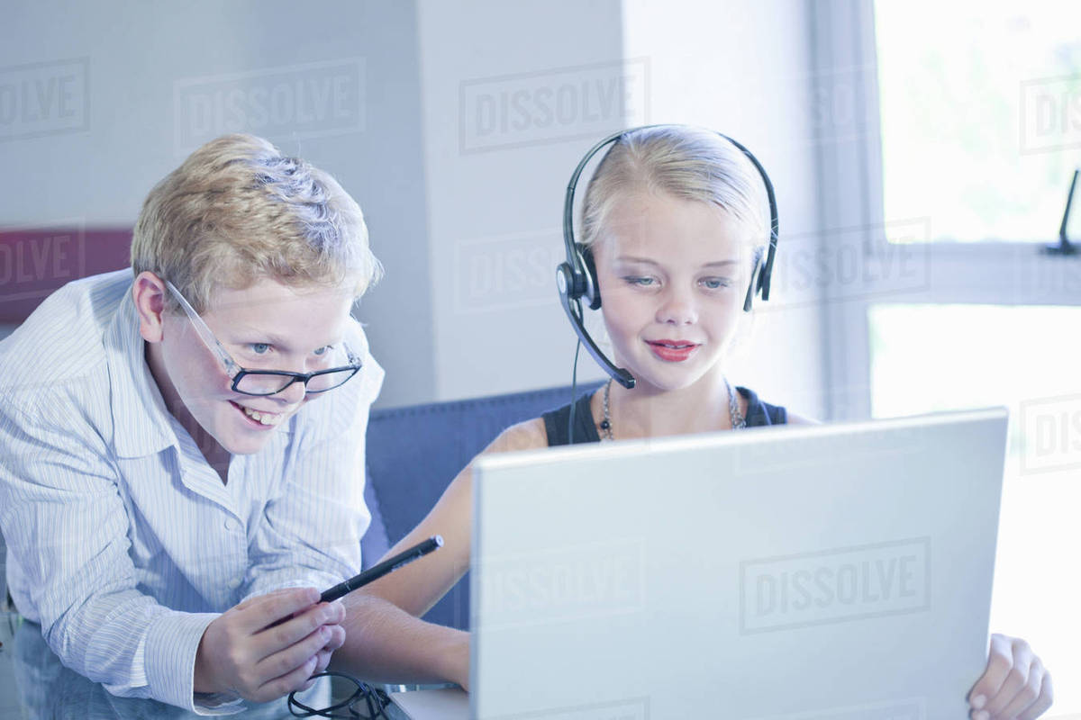 Children playing business people at desk - Stock Photo - Dissolve