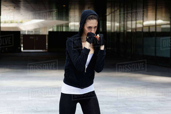 Young woman outdoors, exercising, in fighting stance - Stock Photo ...