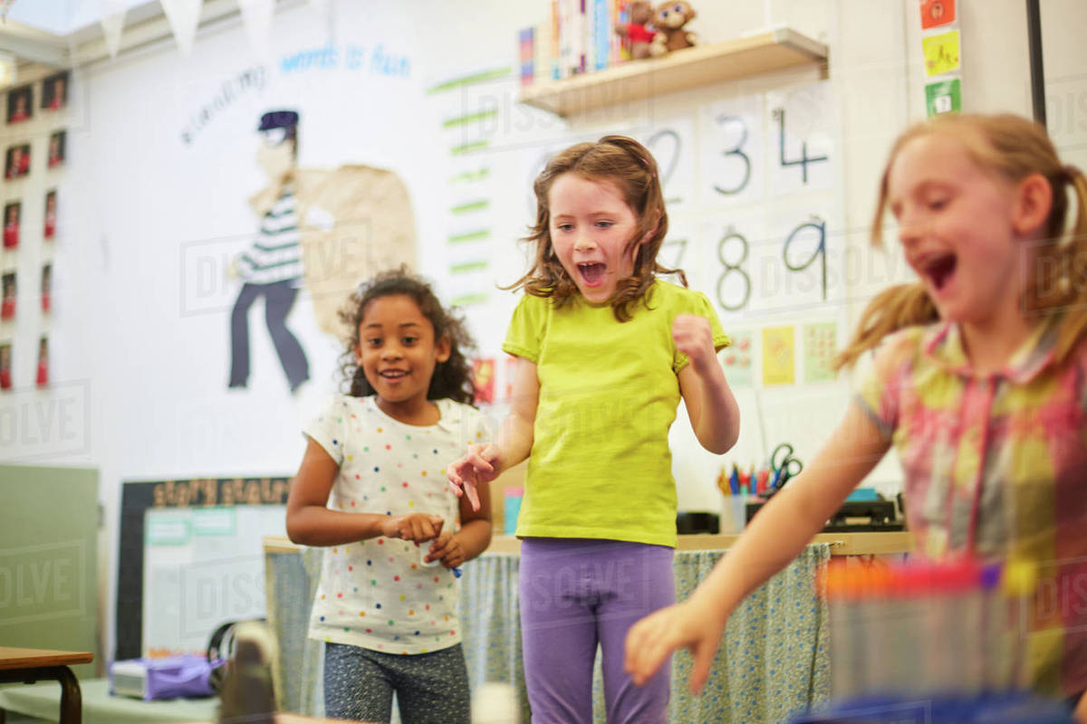 Primary schoolgirls fooling around in classroom - Royalty-free Stock ...