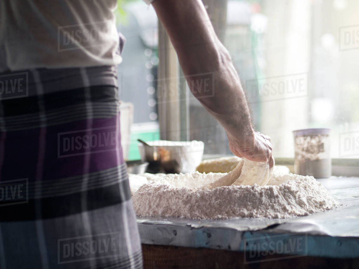 Man preparing roti dough - Royalty-free Stock Photo | Dissolve