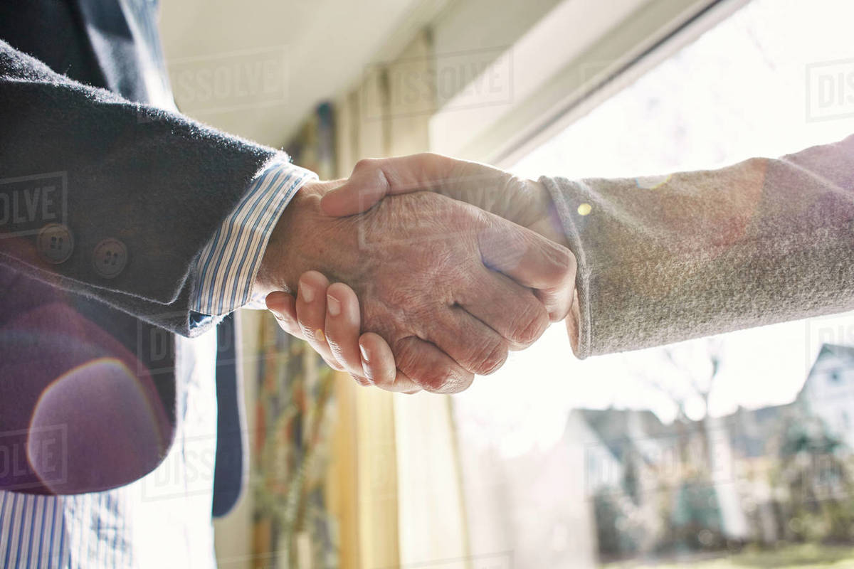 Two women shaking hands, close-up - Royalty-free Stock Photo | Dissolve