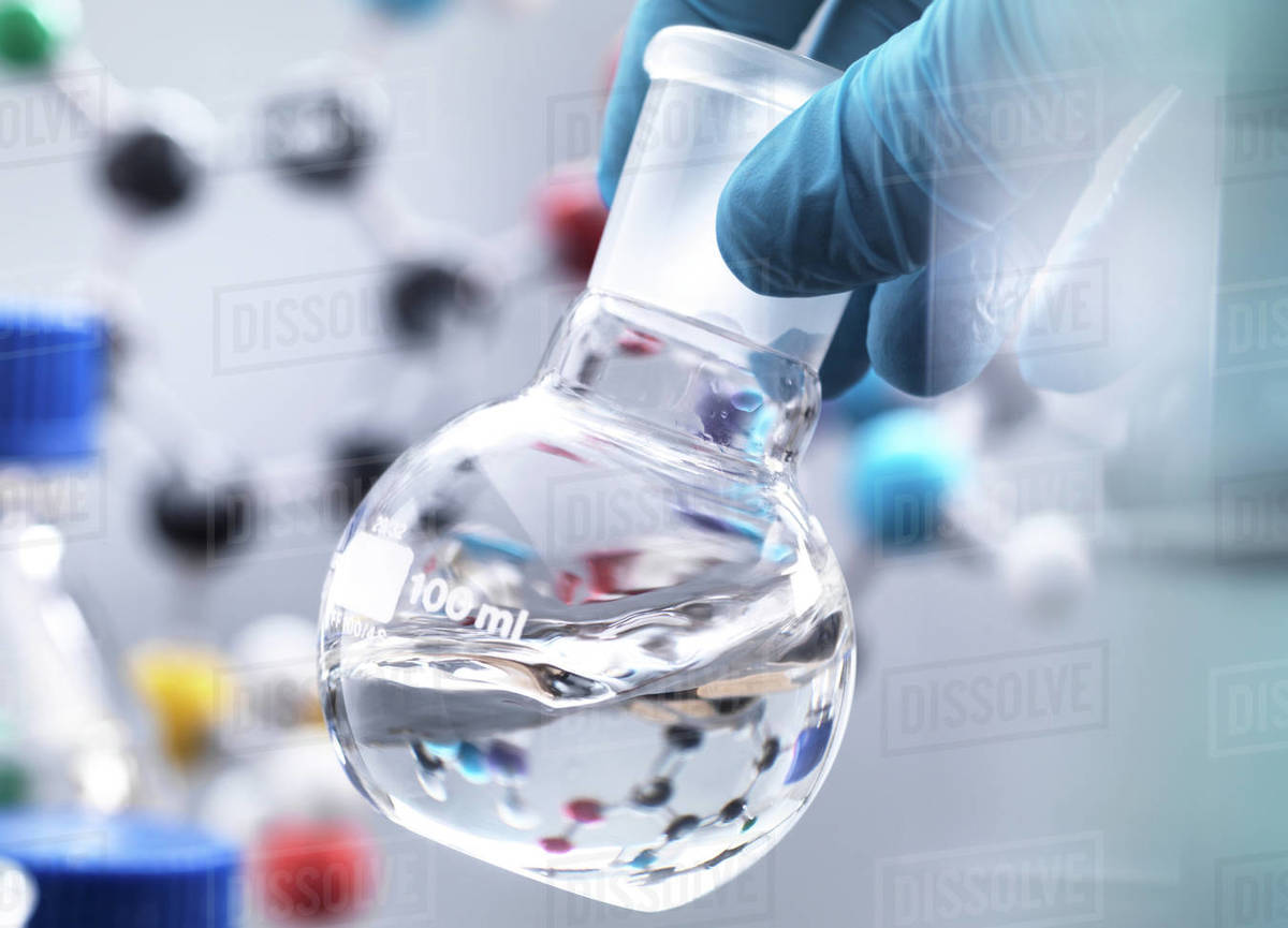 Scientist preparing chemical formula in a laboratory flask during an ...