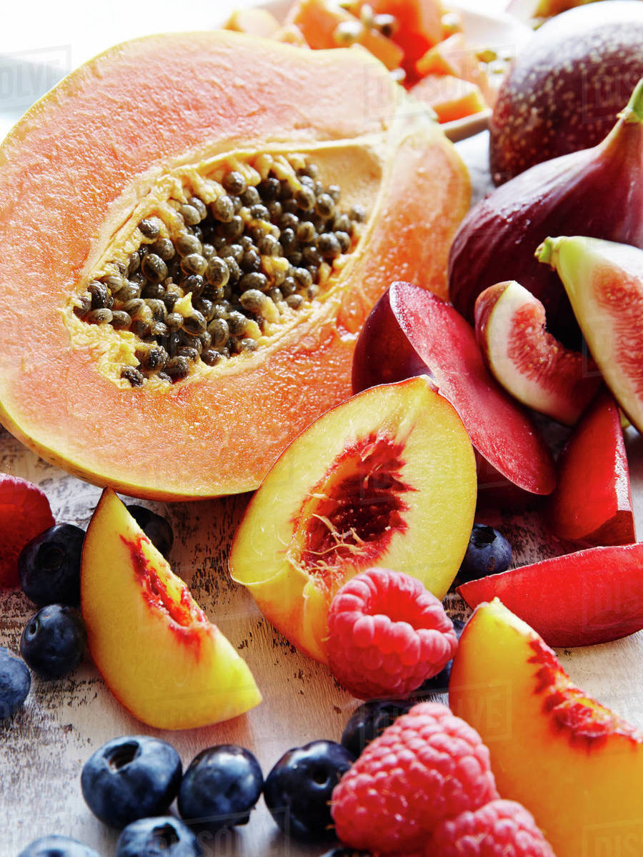 Still life of variety of sliced fresh fruit, overhead view - Royalty ...