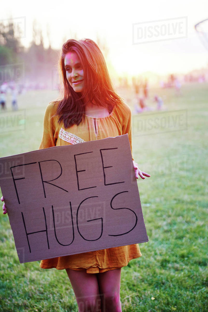 Young woman holding free hug sign at Holi Festival - Royalty-free Stock ...