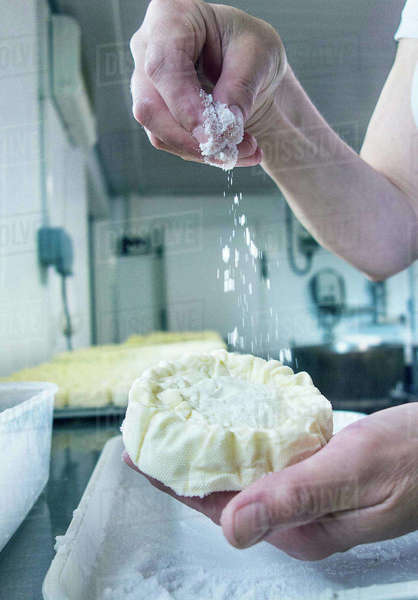 Female cheesemaker sprinkling cheese, close up of hands - Stock Photo ...