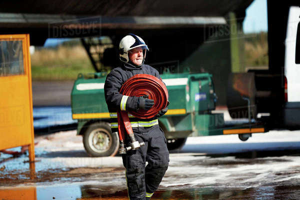 Fireman carrying fire hose reel, Darlington, UK - Royalty-free Stock ...