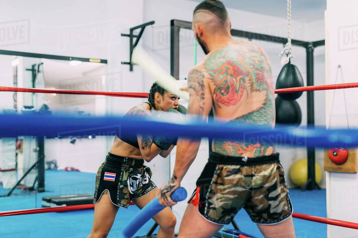 Male and female boxers working out in boxing ring - Stock Photo - Dissolve