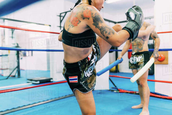 Male and female boxers working out in boxing ring - Stock Photo - Dissolve