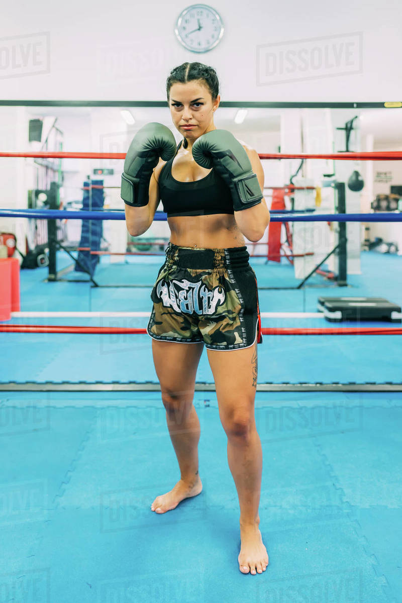 Portrait of female boxer in boxing ring - Stock Photo - Dissolve