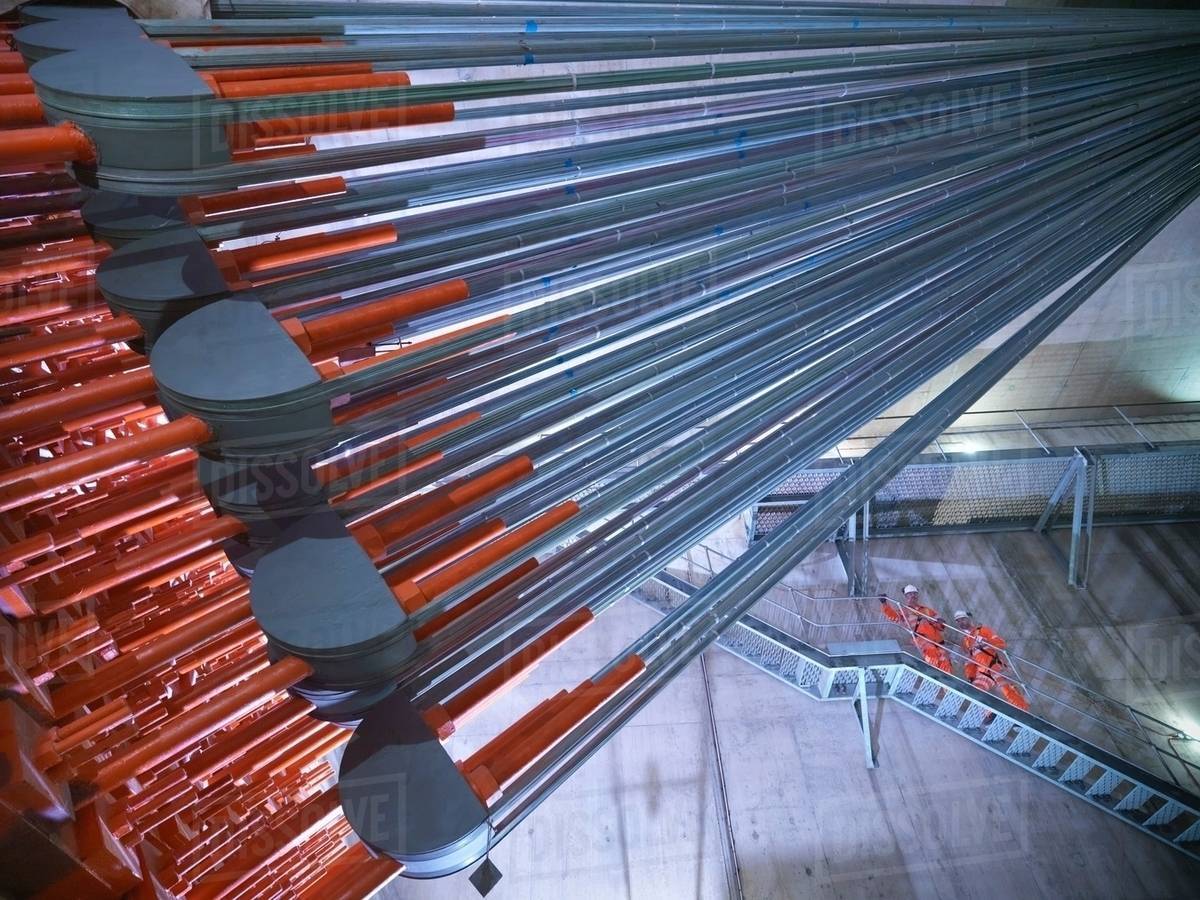 Engineers on staircase with cable anchorage in suspension bridge in ...